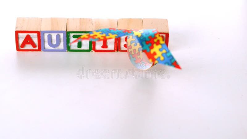 Awareness Ribbon Falling in Front of Autism Letter Blocks Stock Video ...
