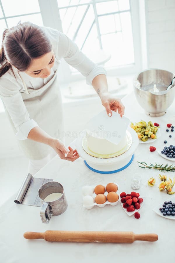 Awesome Chef Smooths White Cream on a Biscuit Cake Stock Photo - Image ...