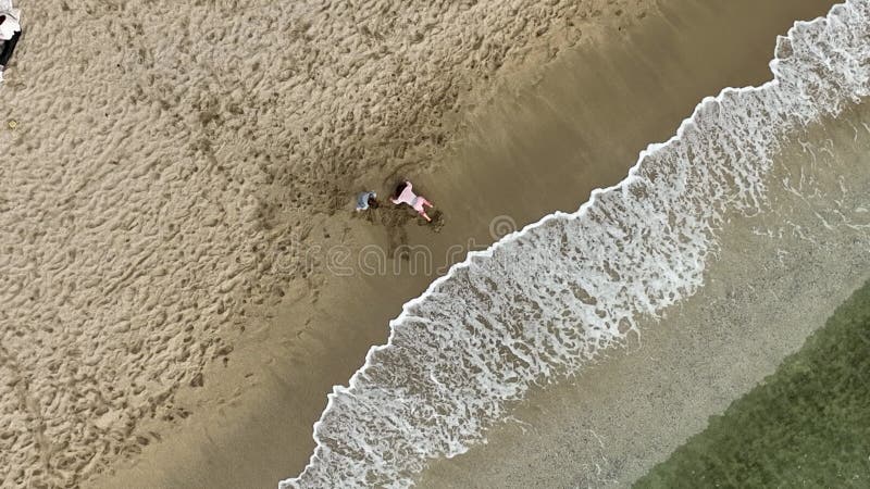 Kids Playing on the Beach Aerial View 4 K Stock Video - Video of ...