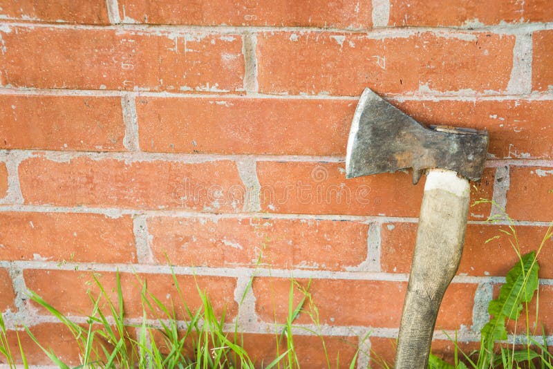 The Ax Near the Red Brick Wall of the House Stock Photo - Image of ...