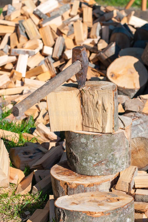 Axe in Chopping Block and Firewood. Ax Pile of Stock Image - Image of ...