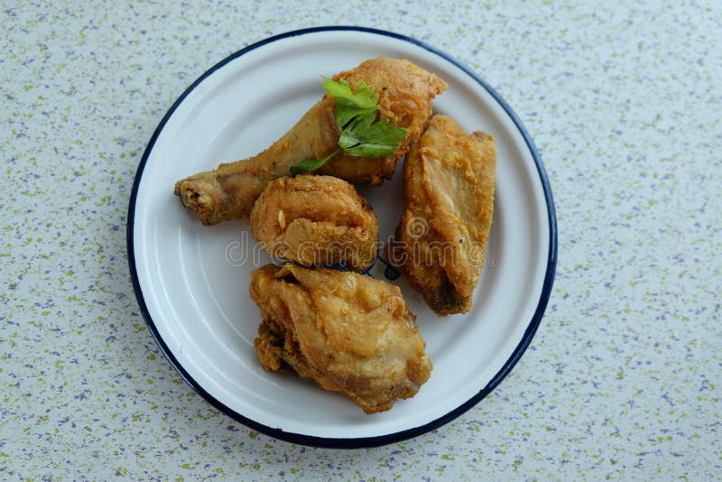 Ayam Goreng or Spicy Fried Chicken on White Plate Stock Photo - Image ...