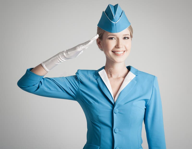 Azafata Encantadora in Blue Uniform En Gray Background Foto de archivo ...