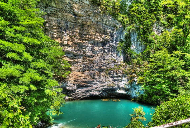 Azure lake in Abkhazia stock image. Image of cliff, forest - 78678607