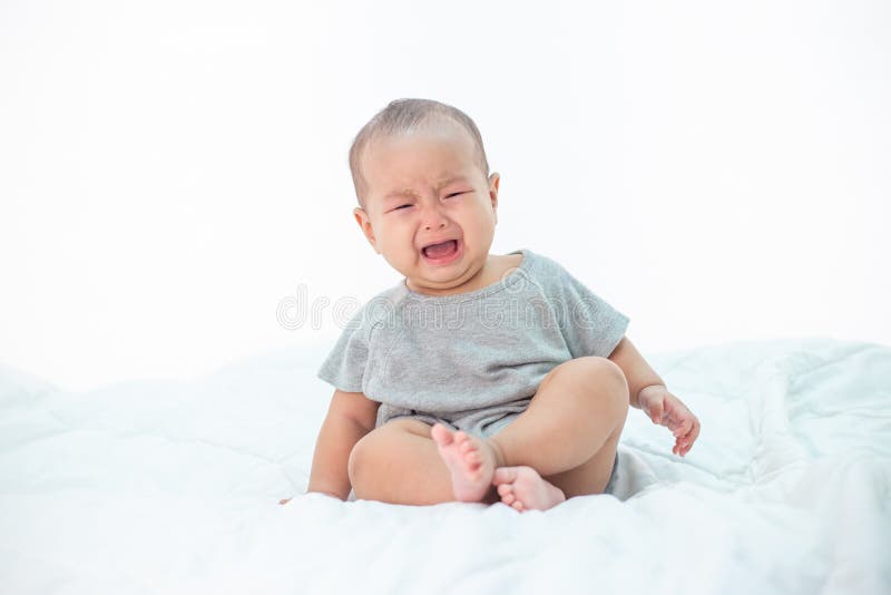 Babies are sad on the bed stock image. Image of portrait - 167838309