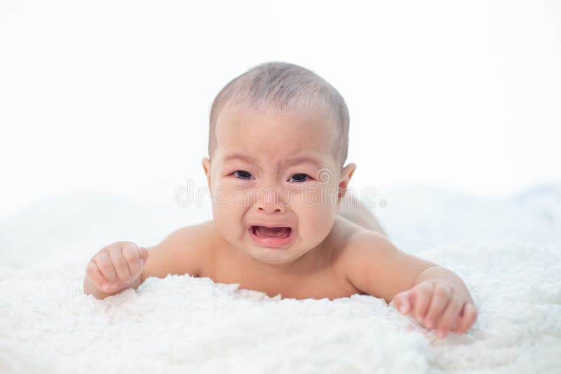 Babies are sad on the bed stock photo. Image of newborn - 167838496