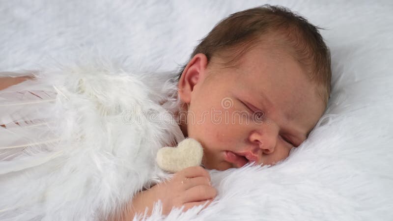 Baby with Angel Wings Sleeps on the Bed. Selective Focus Stock Footage ...