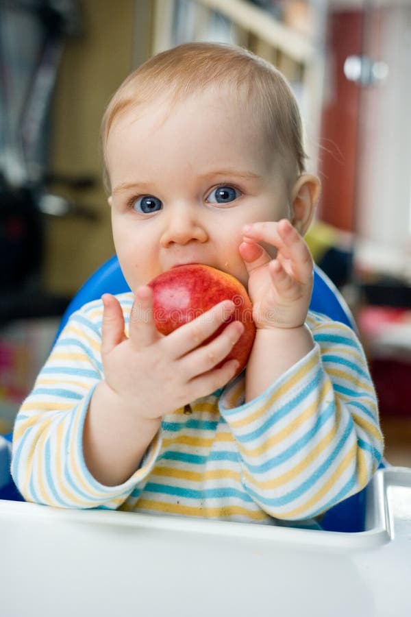 Baby with an Apple at Home; Vertical Stock Image - Image of background ...