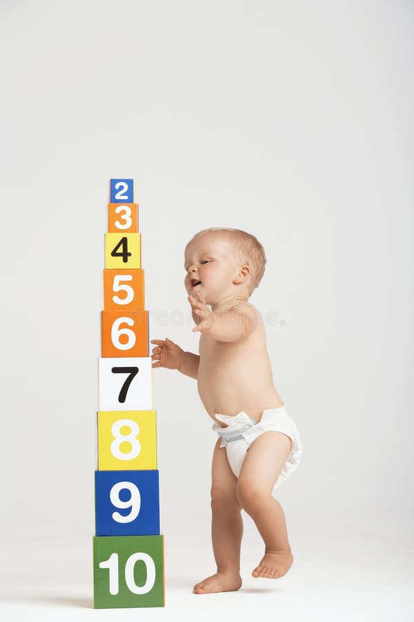 Baby Approaching Tower of Number Blocks Stock Photo - Image of standing ...
