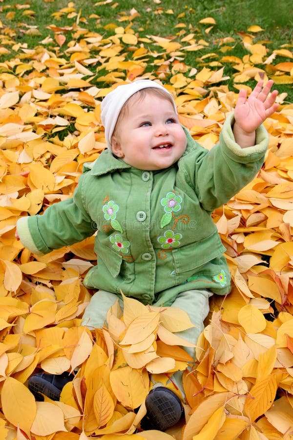 Baby in autumn leaves stock image. Image of fall, yellow - 1938533