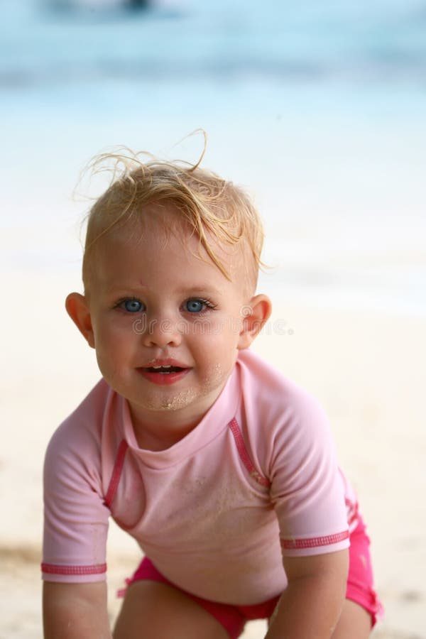 Baby at the beach stock image. Image of swim, play, pink - 12586655