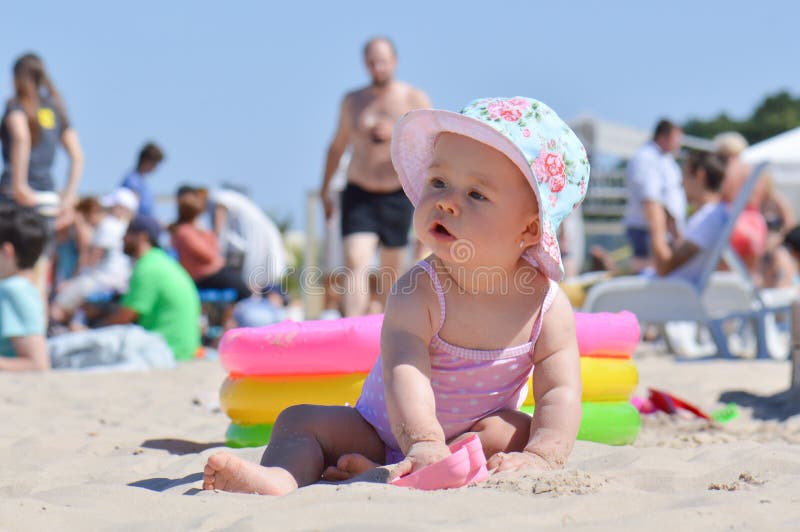 Baby on the beach stock image. Image of sand, basin, swinmsuit - 59915319