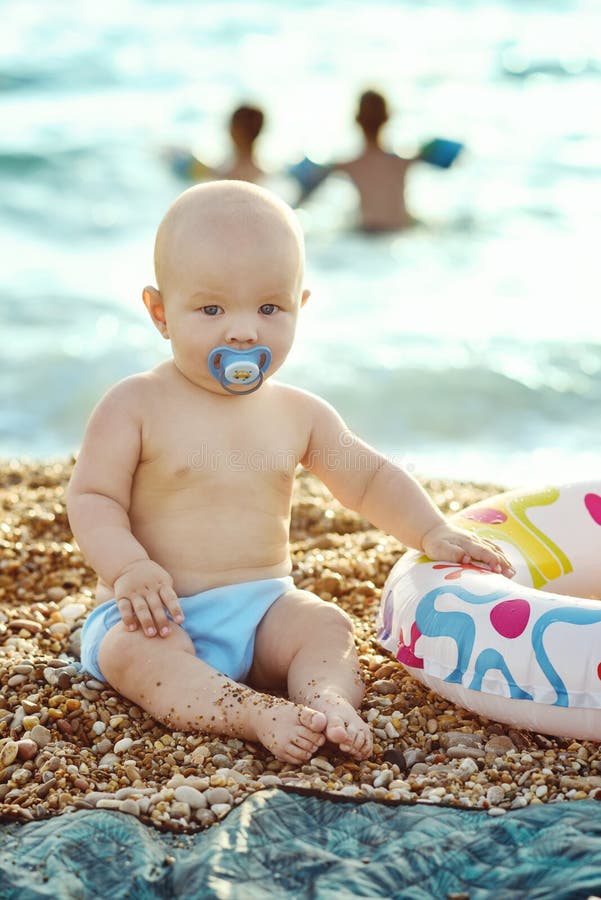 Baby on the beach stock image. Image of inflatable, beach - 110194755