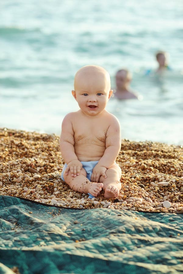 Baby on the beach stock photo. Image of looking, play - 111739282
