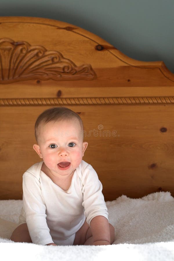 Baby on Bed stock image. Image of grins, infant, flawless - 1818557