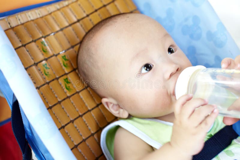 Baby being fed stock image. Image of stroller, bottle - 43017923