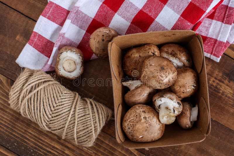 Baby Bella Mushrooms Inside Paper Container on Wooden Table with String ...