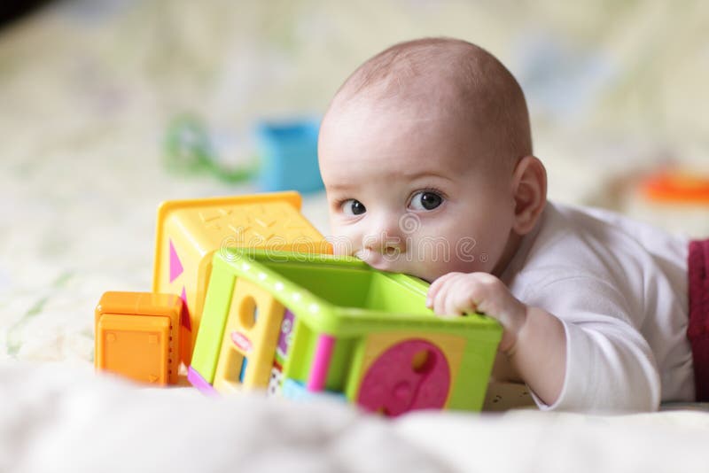 Baby bites toy block stock image. Image of adorable, eating - 23281767