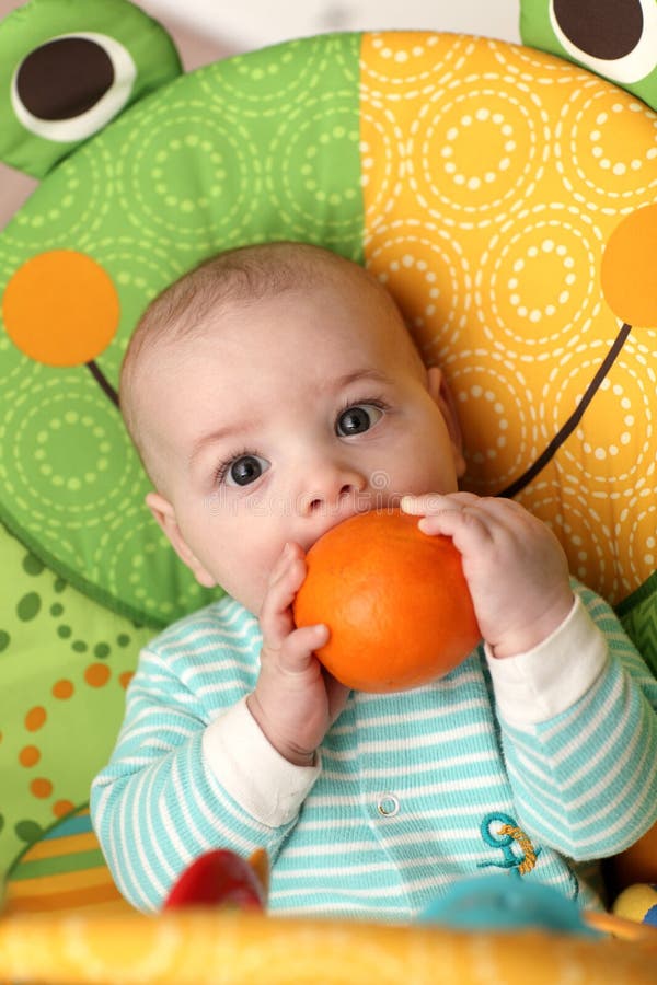 Baby biting orange stock image. Image of beautiful, juicy - 23894303