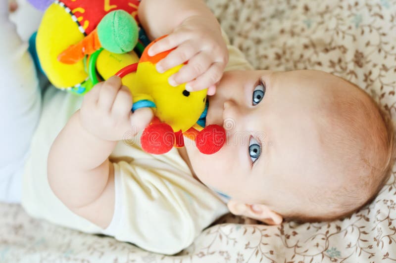 Baby biting toy stock photo. Image of offspring, incisor - 34416428