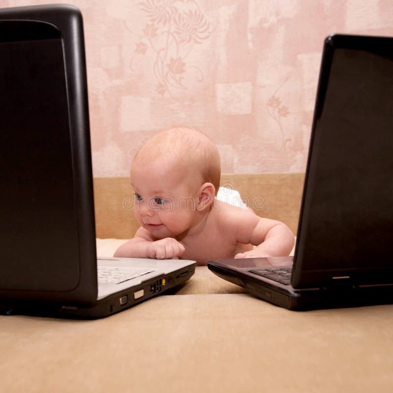 Baby with Blue Eyes Working on Two Laptops Stock Image - Image of ...