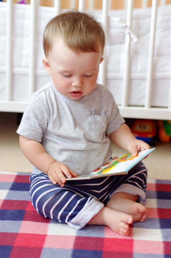 Baby with book at home stock photo. Image of room, reads - 33547918