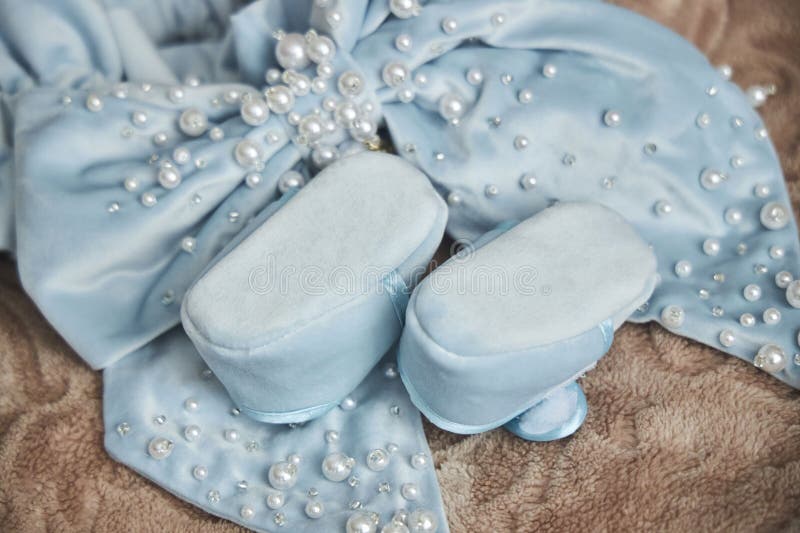Baby Booties of Blue Color Lie on a Blue Bow Stock Image - Image of ...