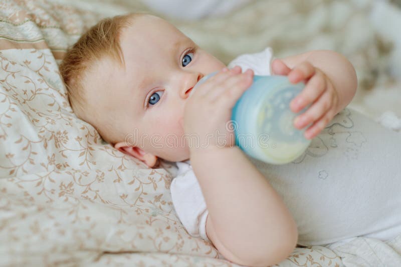 Baby with a bottle stock image. Image of hungry, drink - 118367373