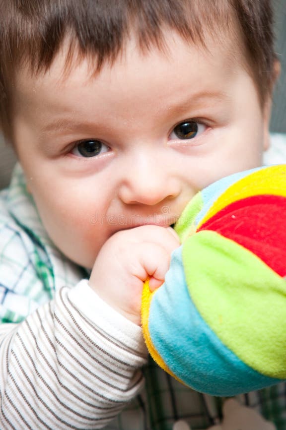Baby boy bites toy stock image. Image of toddler, open - 14218391