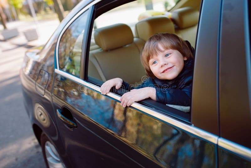 Baby Boy in the Black Car with Beige Interior. Stock Photo - Image of ...