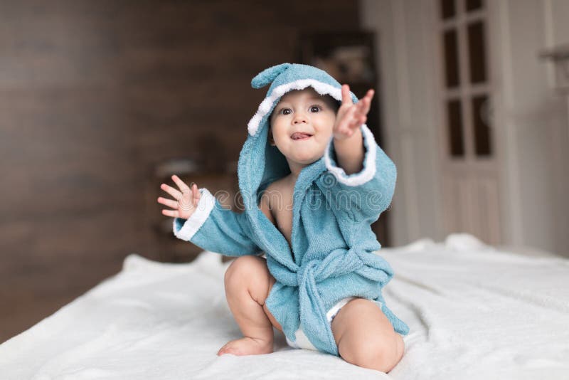 Baby boy in blue robe stock photo. Image of bedroom, home - 93466424