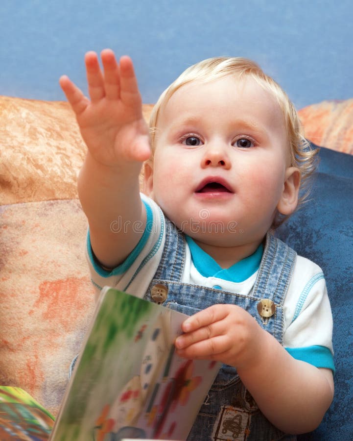 Baby boy with book stock photo. Image of hand, attentive - 10299320