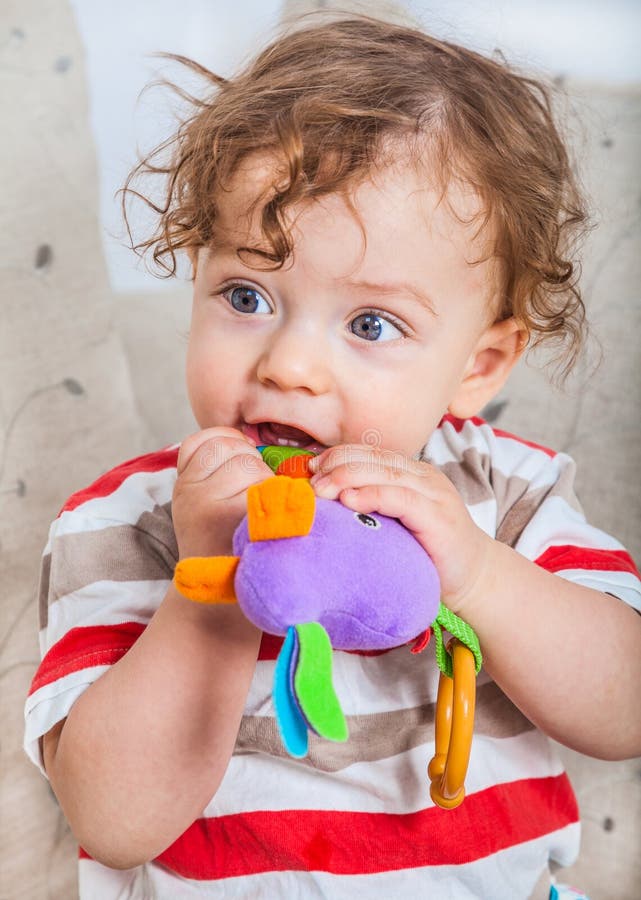 Baby boy chewing toy stock photo. Image of child, period - 105099004