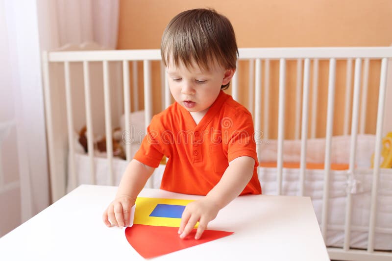 Baby Boy Constructing House of Paper Details Stock Image - Image of ...