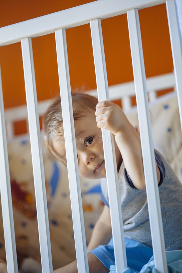 Baby Boy in a Crib stock image. Image of curious, carefree - 59229383