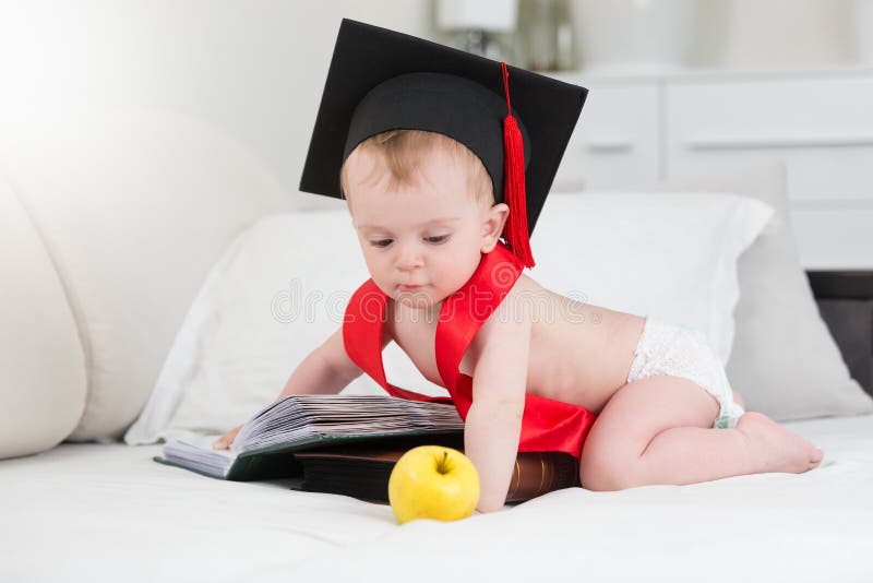 Baby Boy in Graduation Cap Posing with Apple and Big Book Stock Image ...