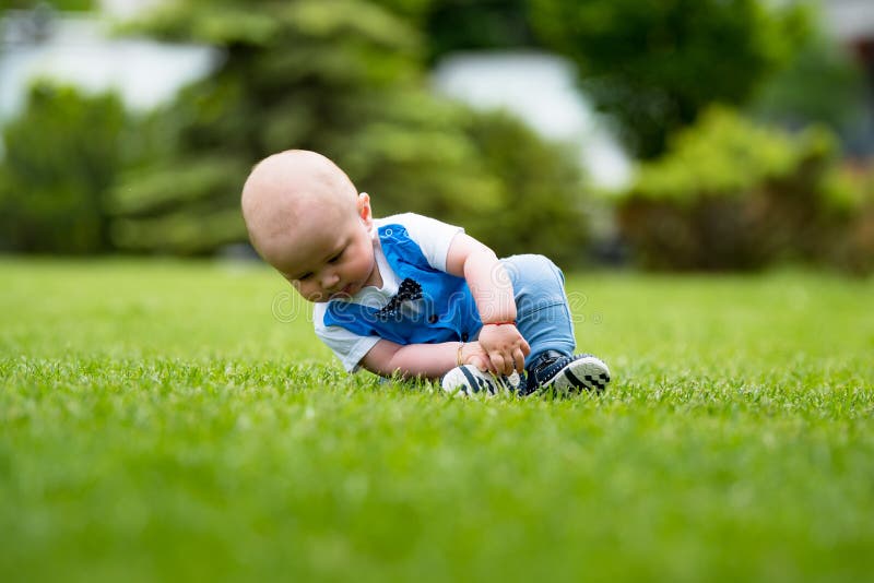 Baby boy on the grass stock image. Image of park, meadow - 188848631