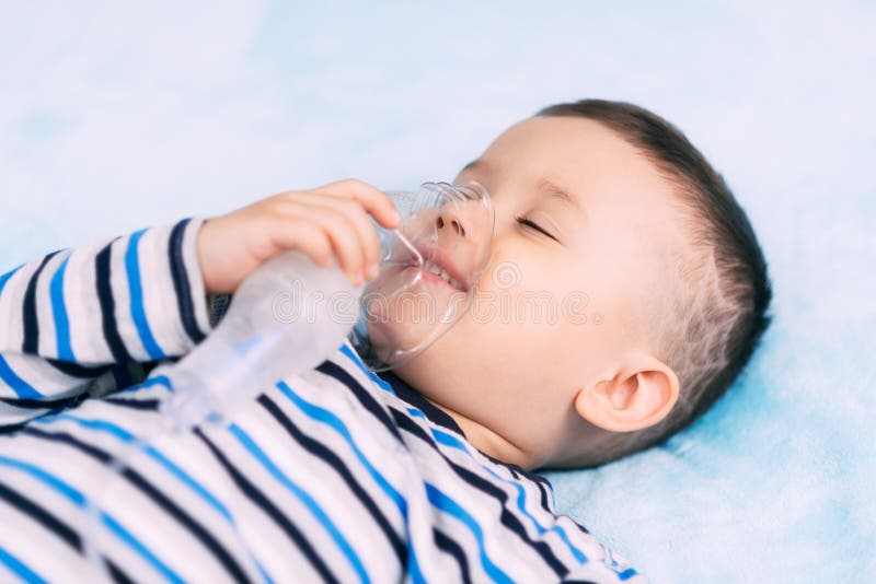 Baby Boy Holding a Mask Immobilizer Sprayer while Taking a Breath Stock ...