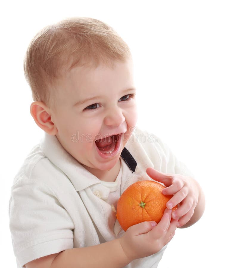 Baby boy holding an orange stock image. Image of child - 13334249
