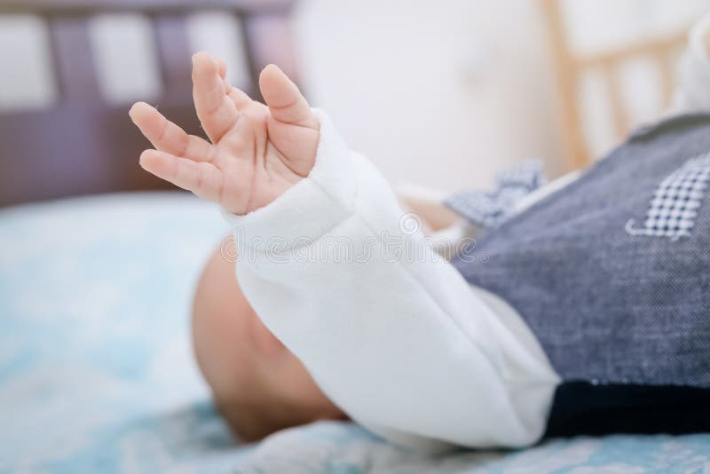 Baby Boy Lay in Bad with Hand Up in the Air Stock Image - Image of ...