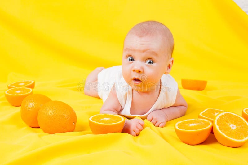 Baby Boy Lies on a Yellow with Oranges Stock Photo - Image of bare ...