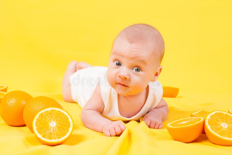 Baby Boy Lies on a Yellow with Oranges Stock Photo - Image of little ...