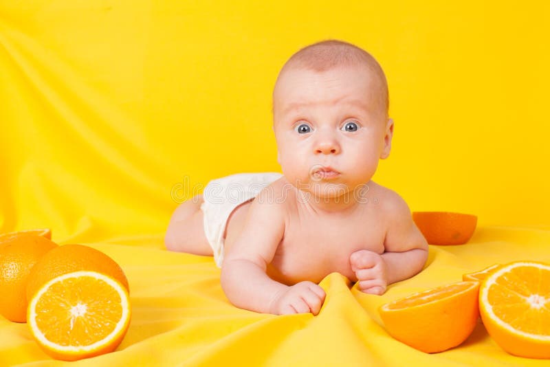 Baby Boy Lies on a Yellow with Oranges Stock Photo - Image of infant ...