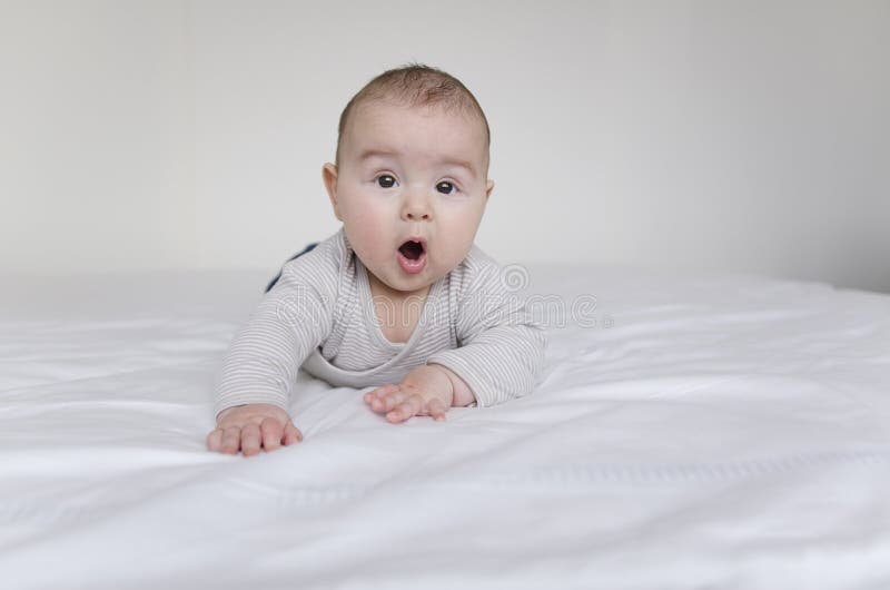 Baby boy lying on belly stock image. Image of clothes - 62517259