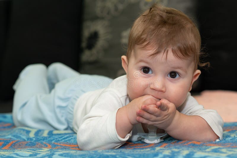 Baby Boy is Lying on Tummy. the Baby Boy Poses and Plays with a ...