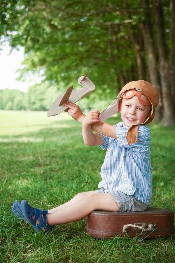 A Baby Boy by the Plane Plays on Nature in the Park. Boy on Vacation ...