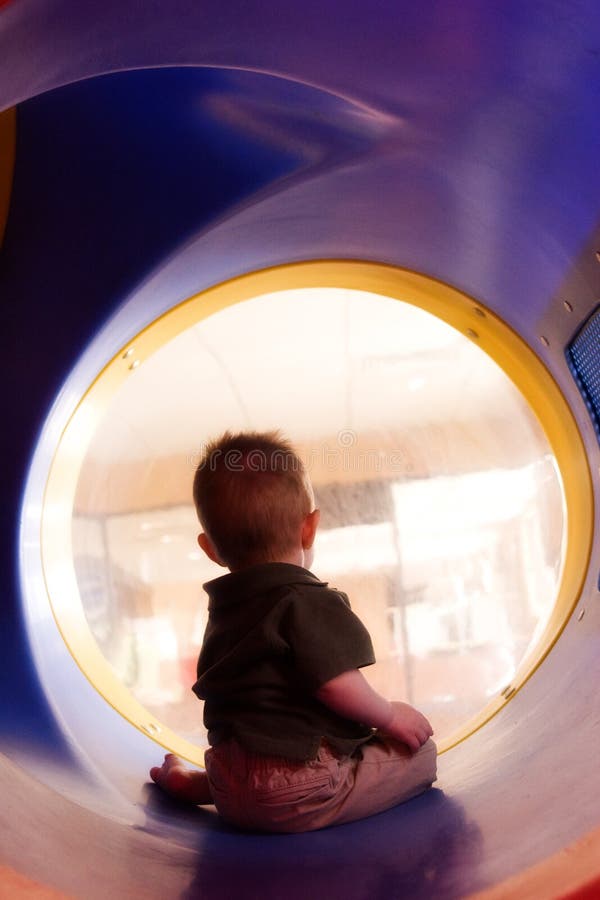 Baby boy playing on slide stock image. Image of enjoyment - 5004423