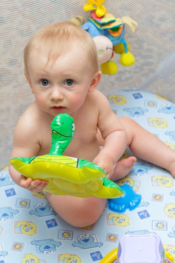 Baby boy plays with turtle stock photo. Image of closeup - 25305710