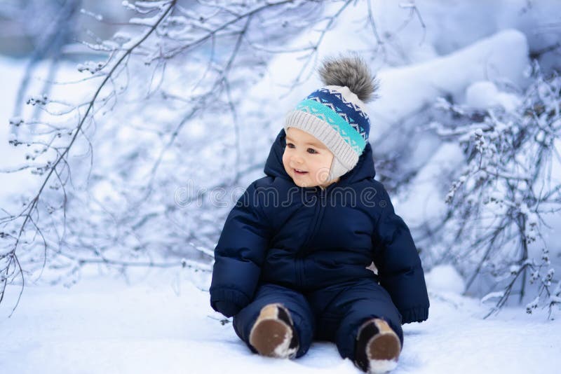Baby boy sitting on snow stock image. Image of cheerful - 138425261