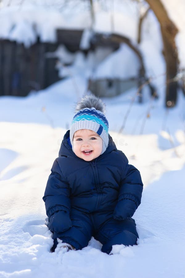 Baby boy sitting on snow stock image. Image of snow - 138425371